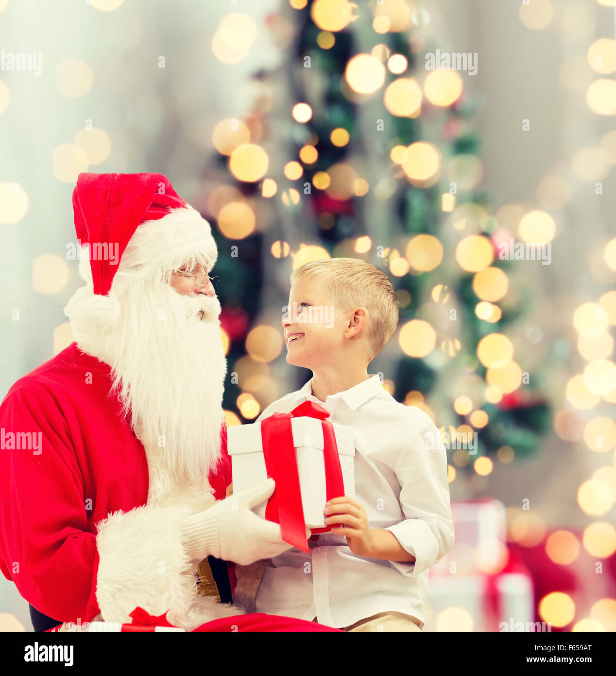 smiling little boy with santa claus and gifts Stock Photo - Alamy