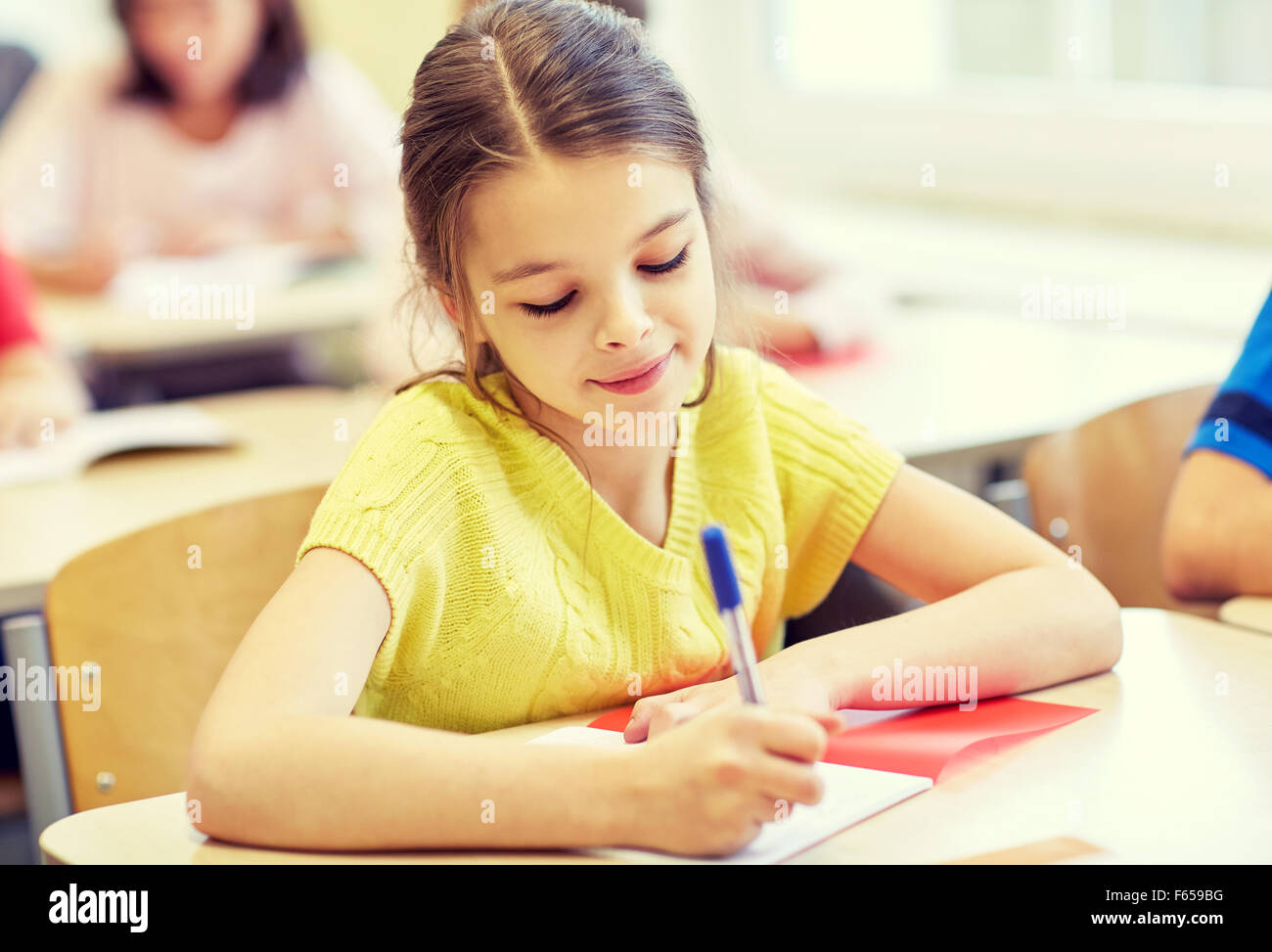 group of school kids writing test in classroom Stock Photo - Alamy