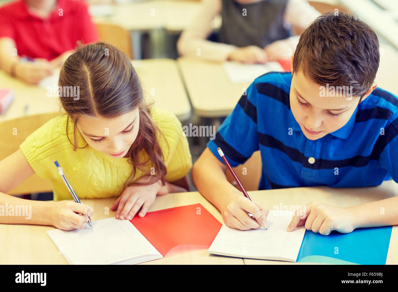 group of school kids writing test in classroom Stock Photo - Alamy