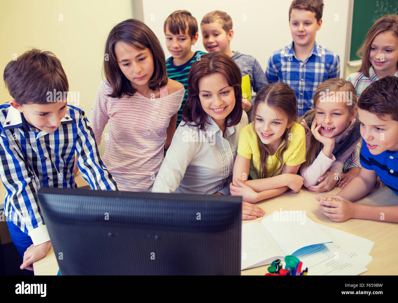 group of kids with teacher and computer at school Stock Photo - Alamy
