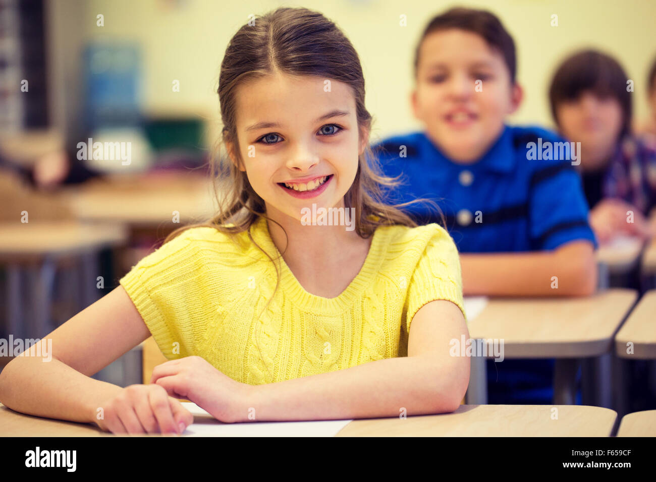 group of school kids with notebooks in classroom Stock Photo - Alamy