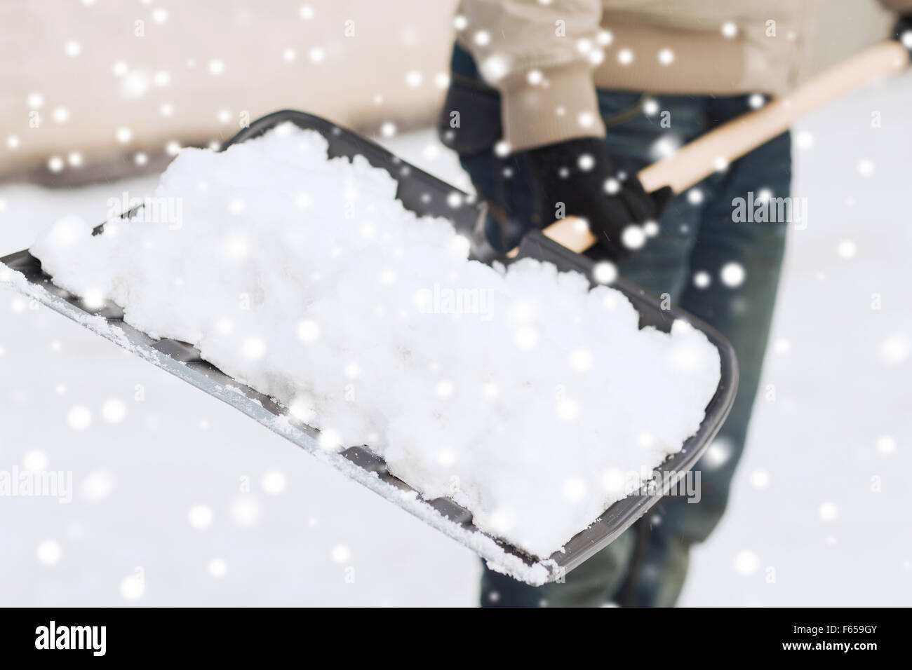 closeup of man digging snow with shovel Stock Photo - Alamy