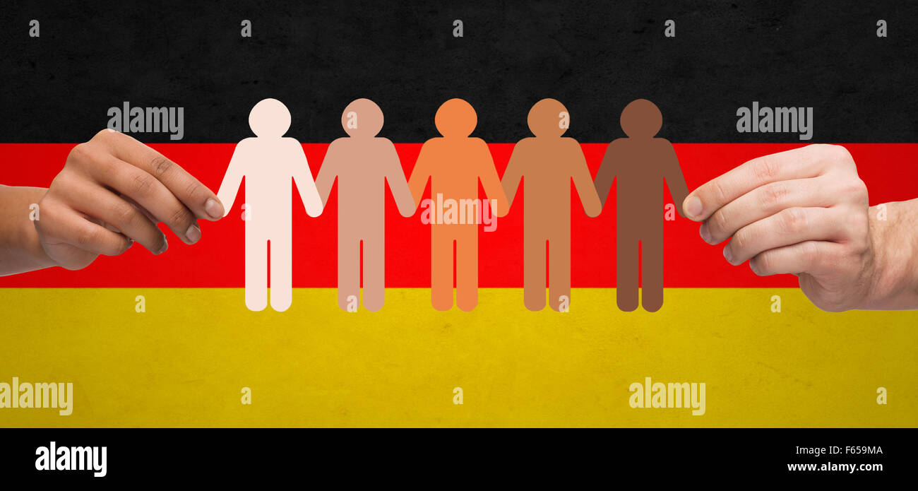 hands with paper people pictogram over german flag Stock Photo - Alamy