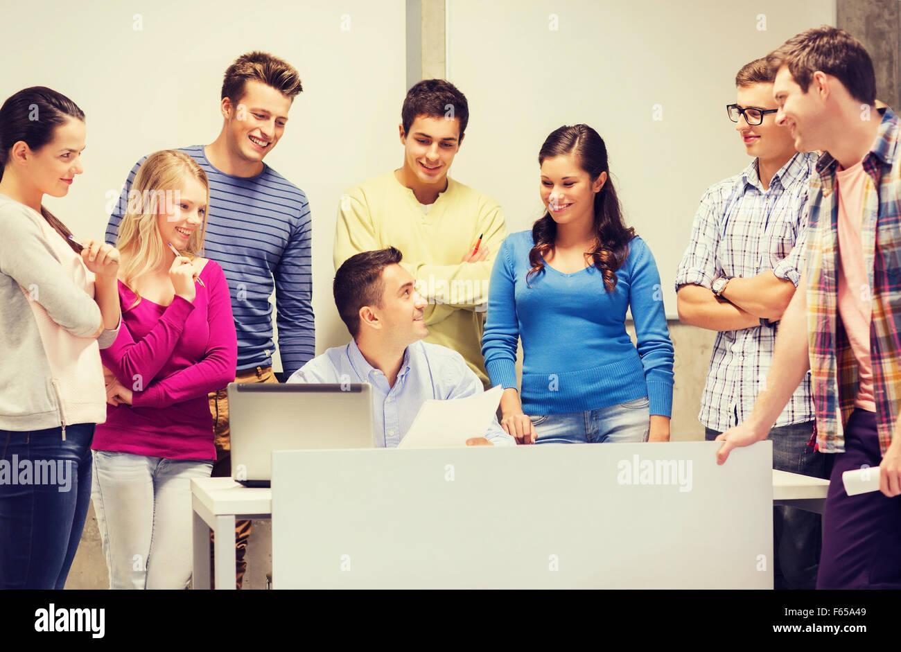 group of students and teacher with laptop Stock Photo - Alamy
