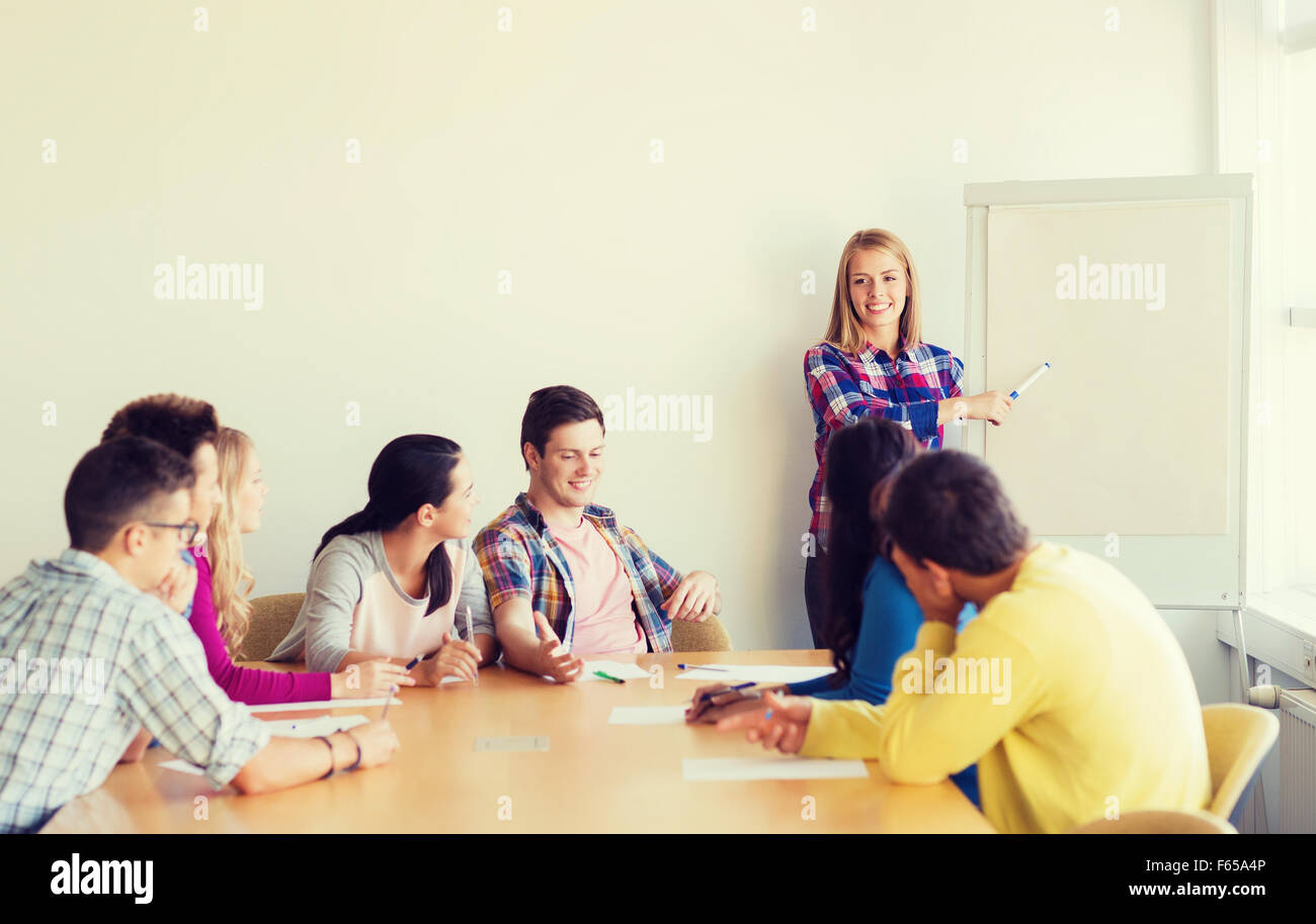 group of smiling students with white board Stock Photo - Alamy