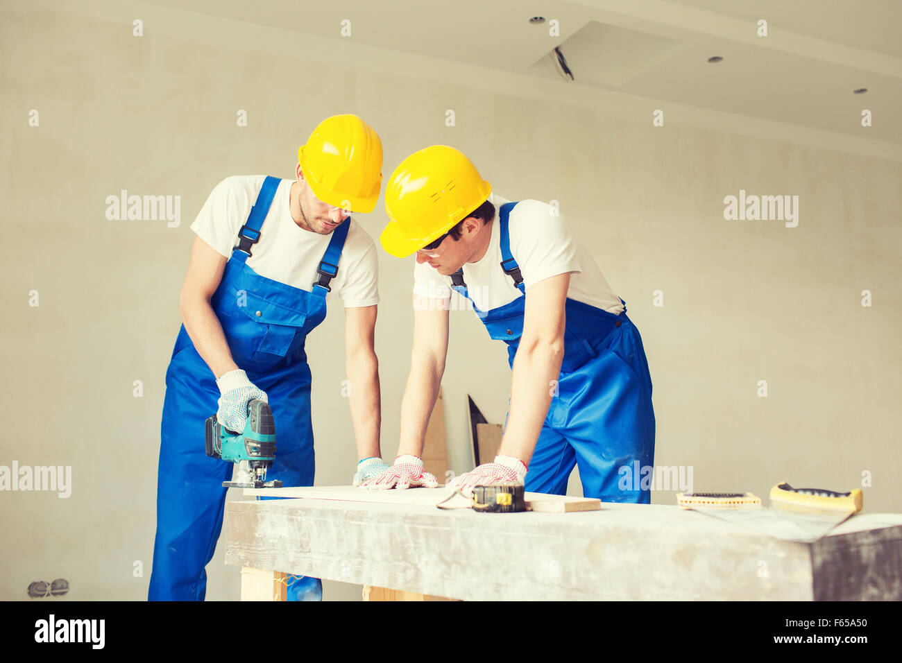 group of builders with tools indoors Stock Photo - Alamy