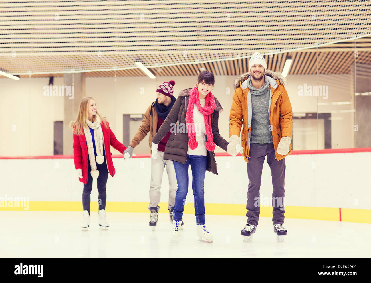 happy friends on skating rink Stock Photo - Alamy