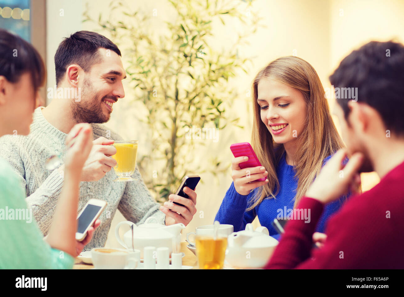 group of friends with smartphones meeting at cafe Stock Photo - Alamy