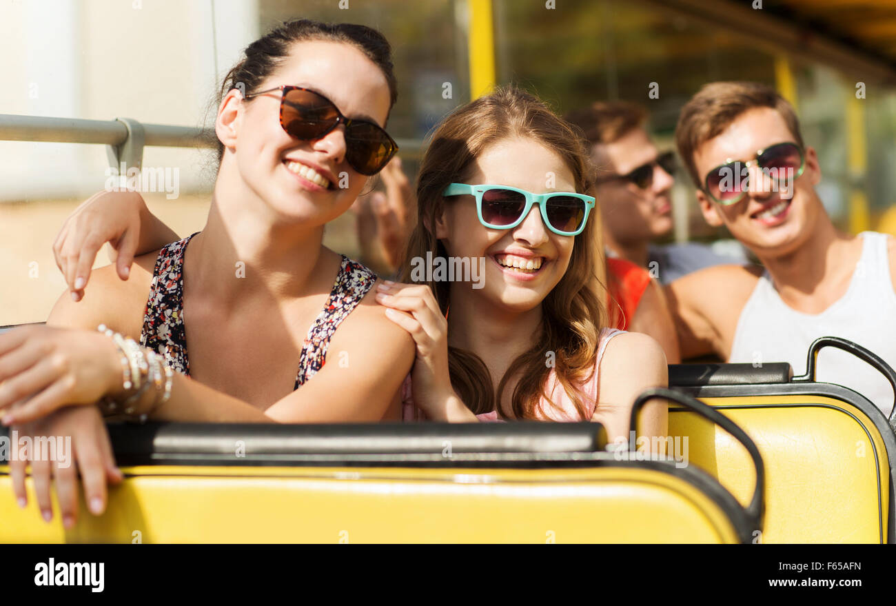 group of smiling friends traveling by tour bus Stock Photo - Alamy