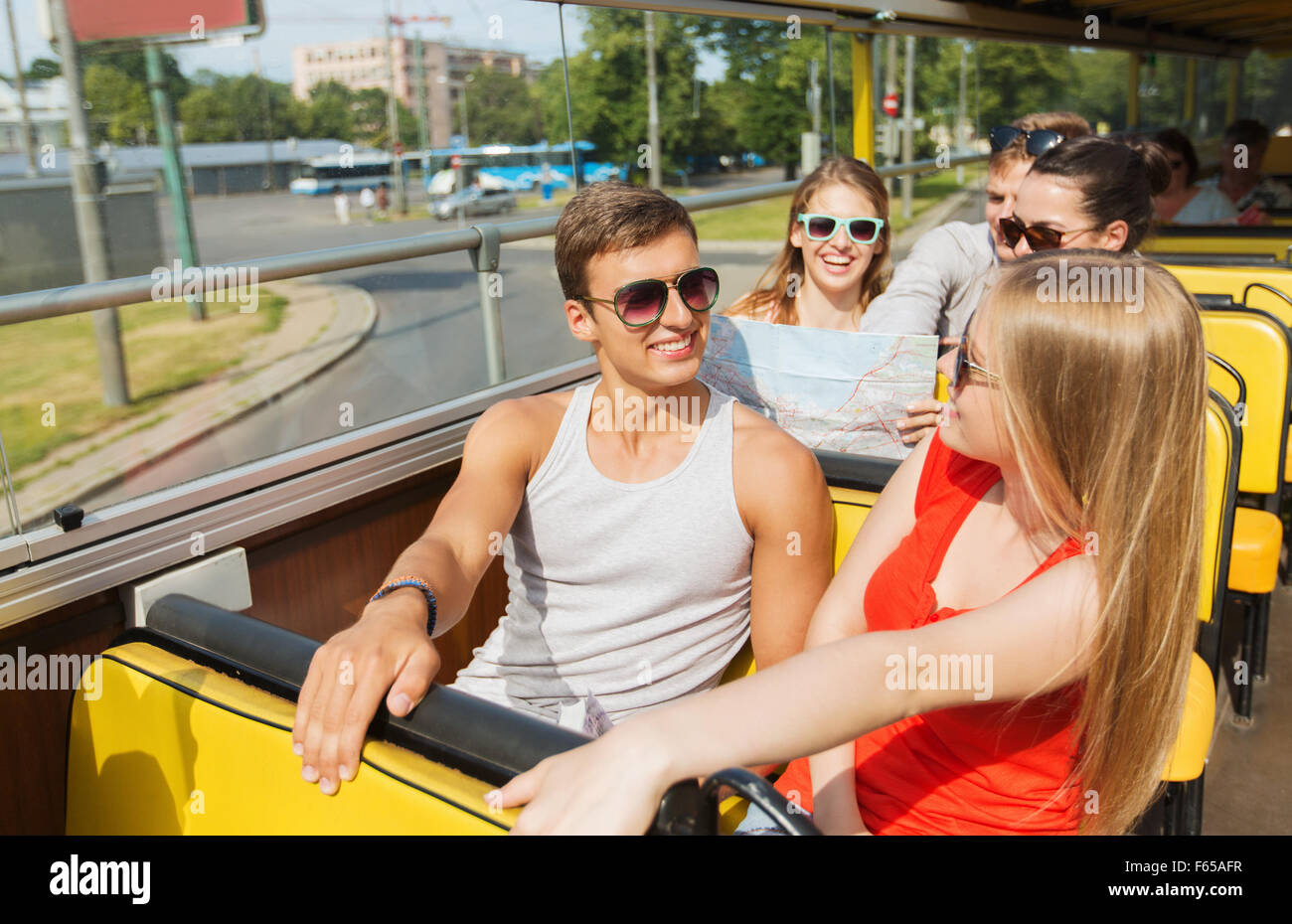group of smiling friends traveling by tour bus Stock Photo - Alamy