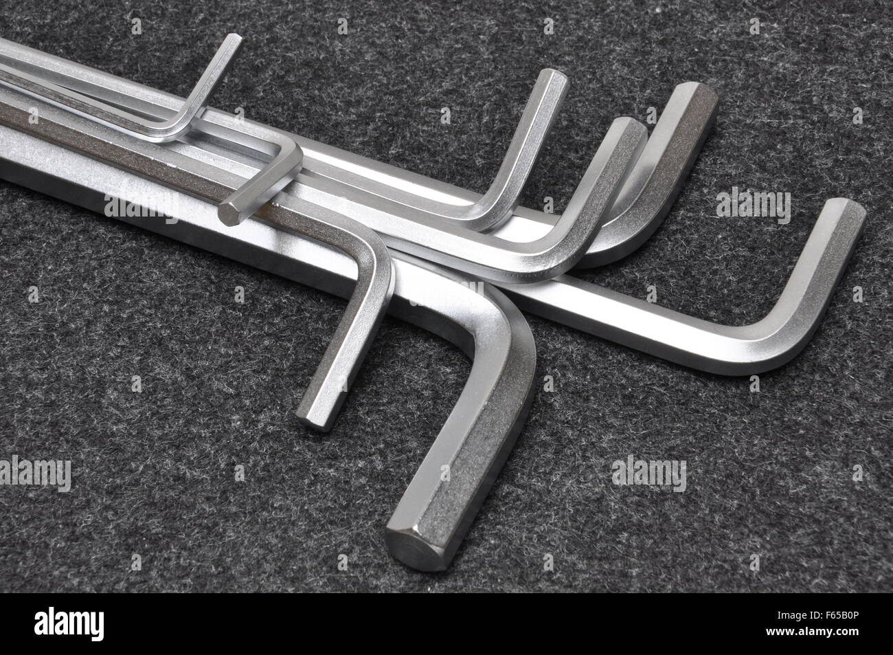 Allen keys on grey felt background Stock Photo - Alamy