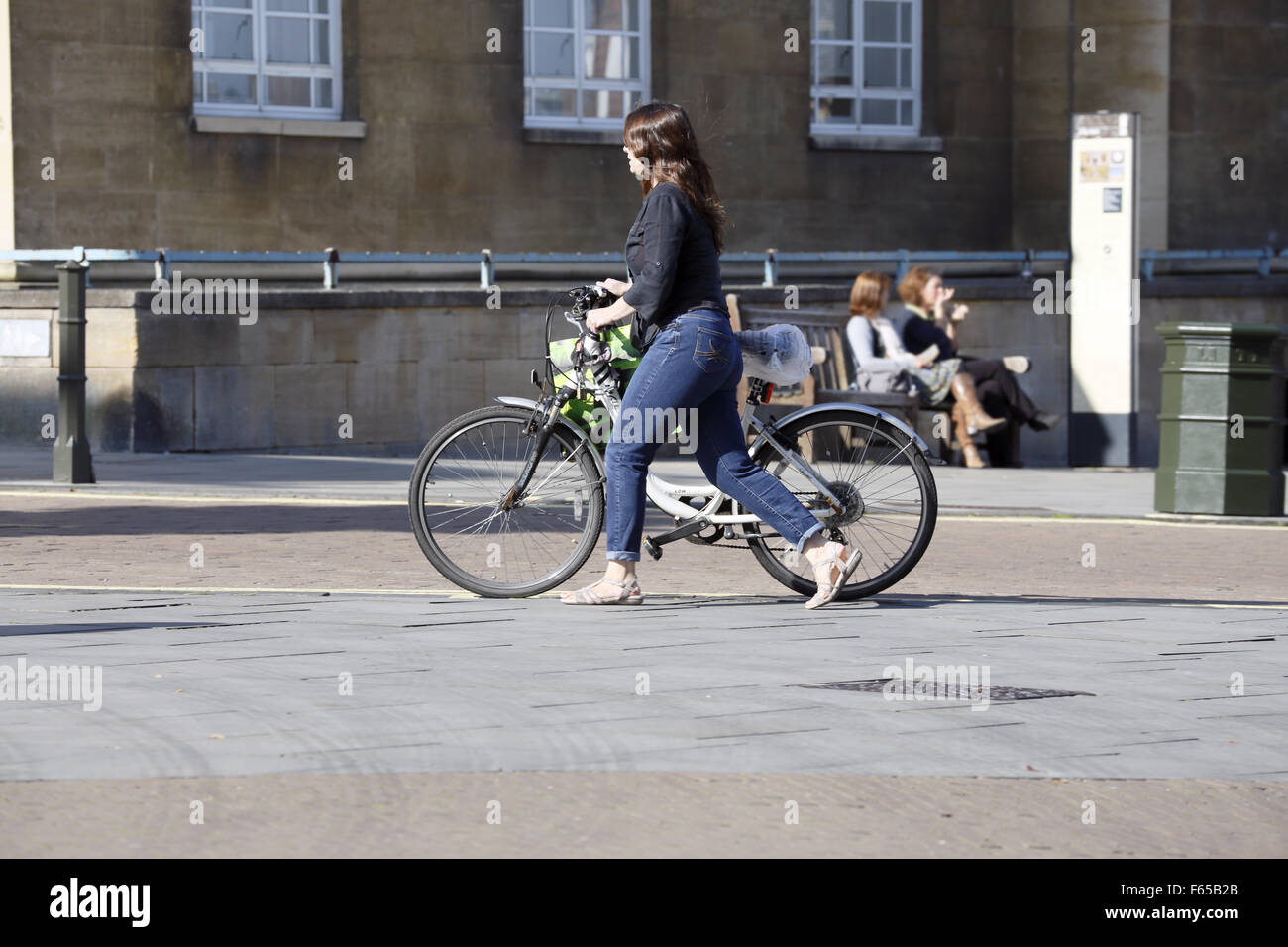 Woman pushing her bicycle hi-res stock photography and images - Alamy