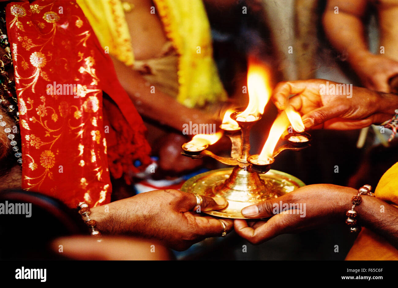 Close-up of Hindu priest performing fire ritual at temple Stock Photo ...