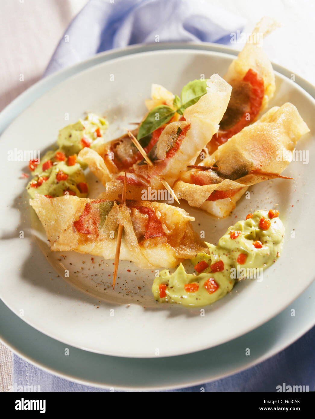 Whiting,avocado and mild pepper fried filo pastry rolls Stock Photo - Alamy