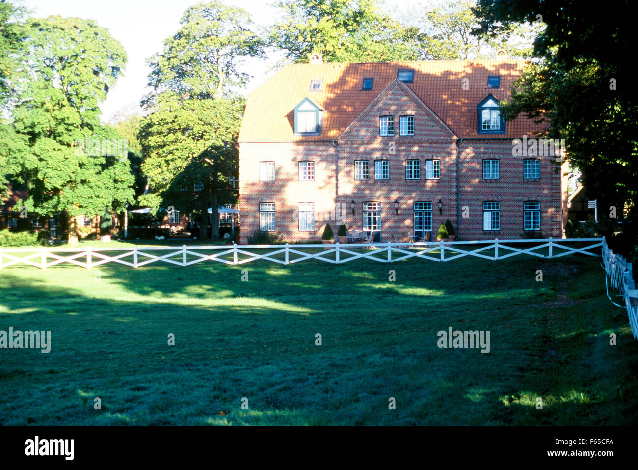 Ole Liese hotel surrounded with trees and white willow fence, Panker ...