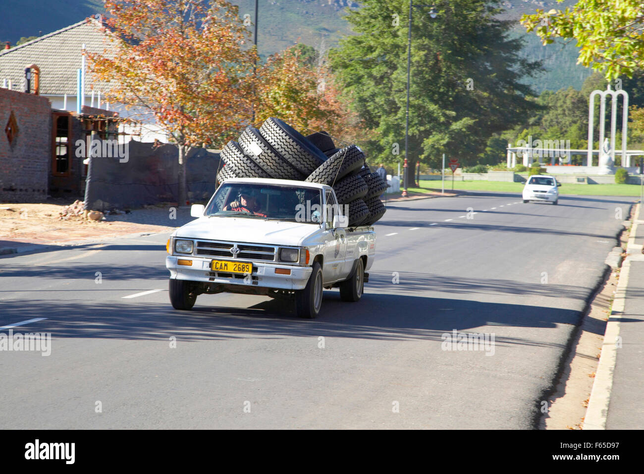 Car loaded with car tires moving on road, Franschhoek, South Africa ...