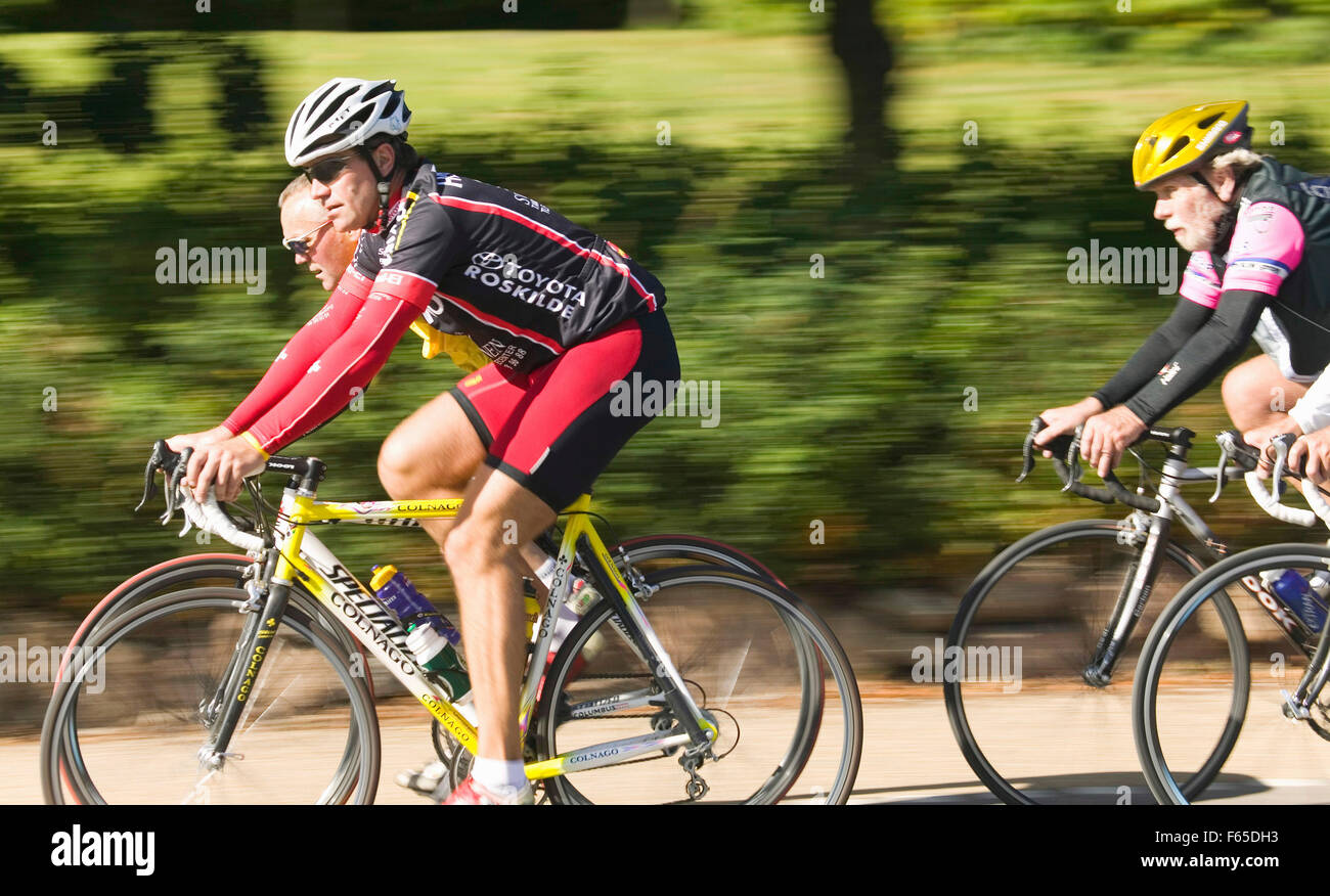 Three men wearing sportswear riding bicycle Stock Photo - Alamy