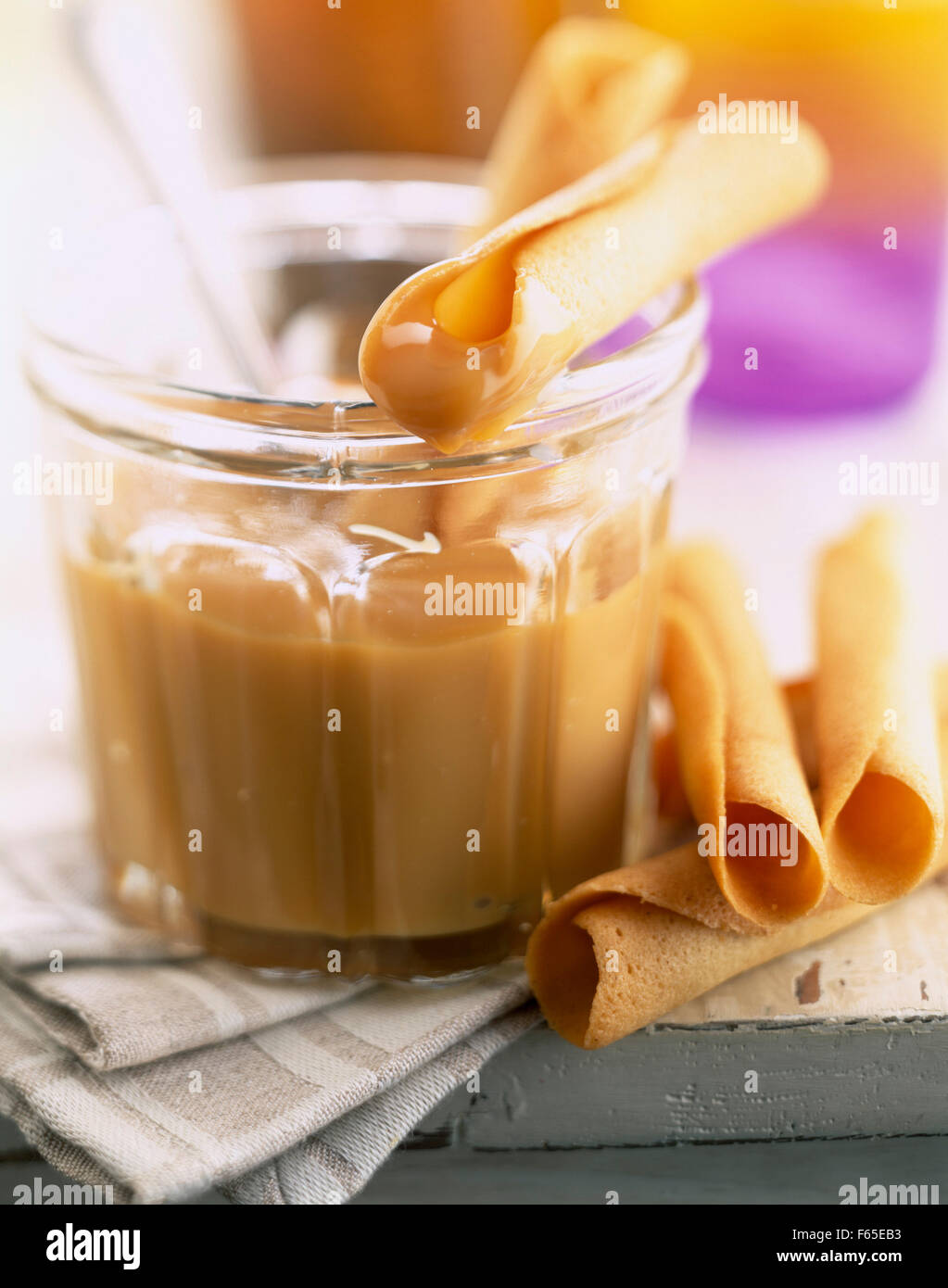 Milk jam with Cigarette Russe rolled biscuits Stock Photo - Alamy
