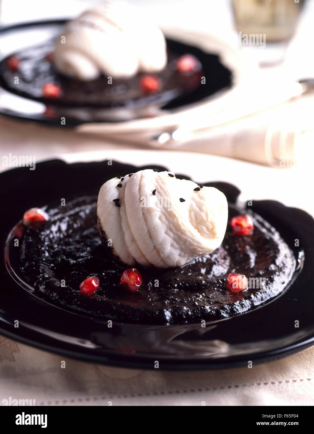 Sole fillet with squid ink sauce Stock Photo - Alamy