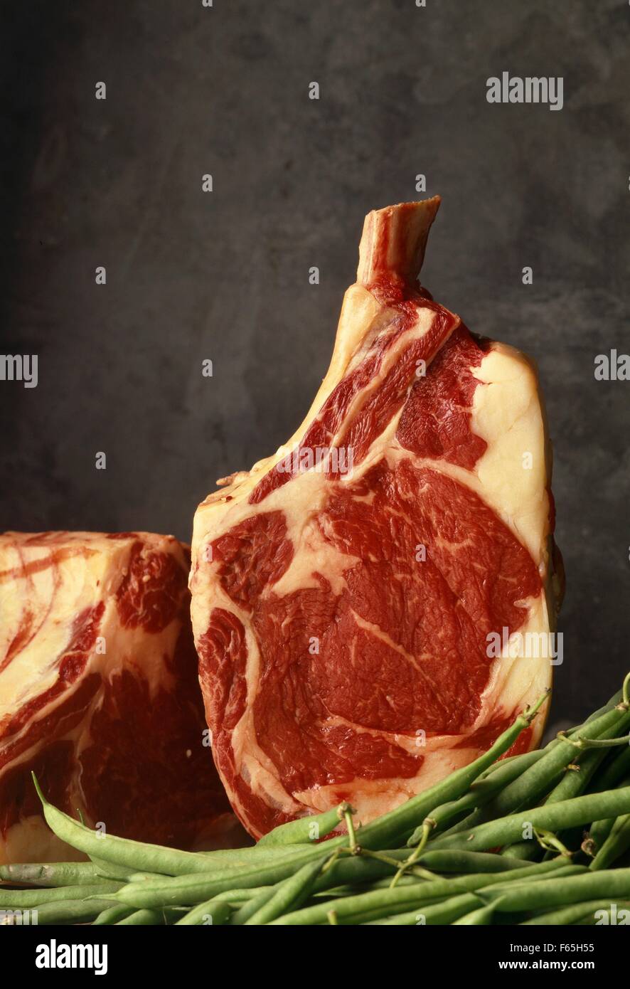 Raw beef chop and green beans Stock Photo - Alamy