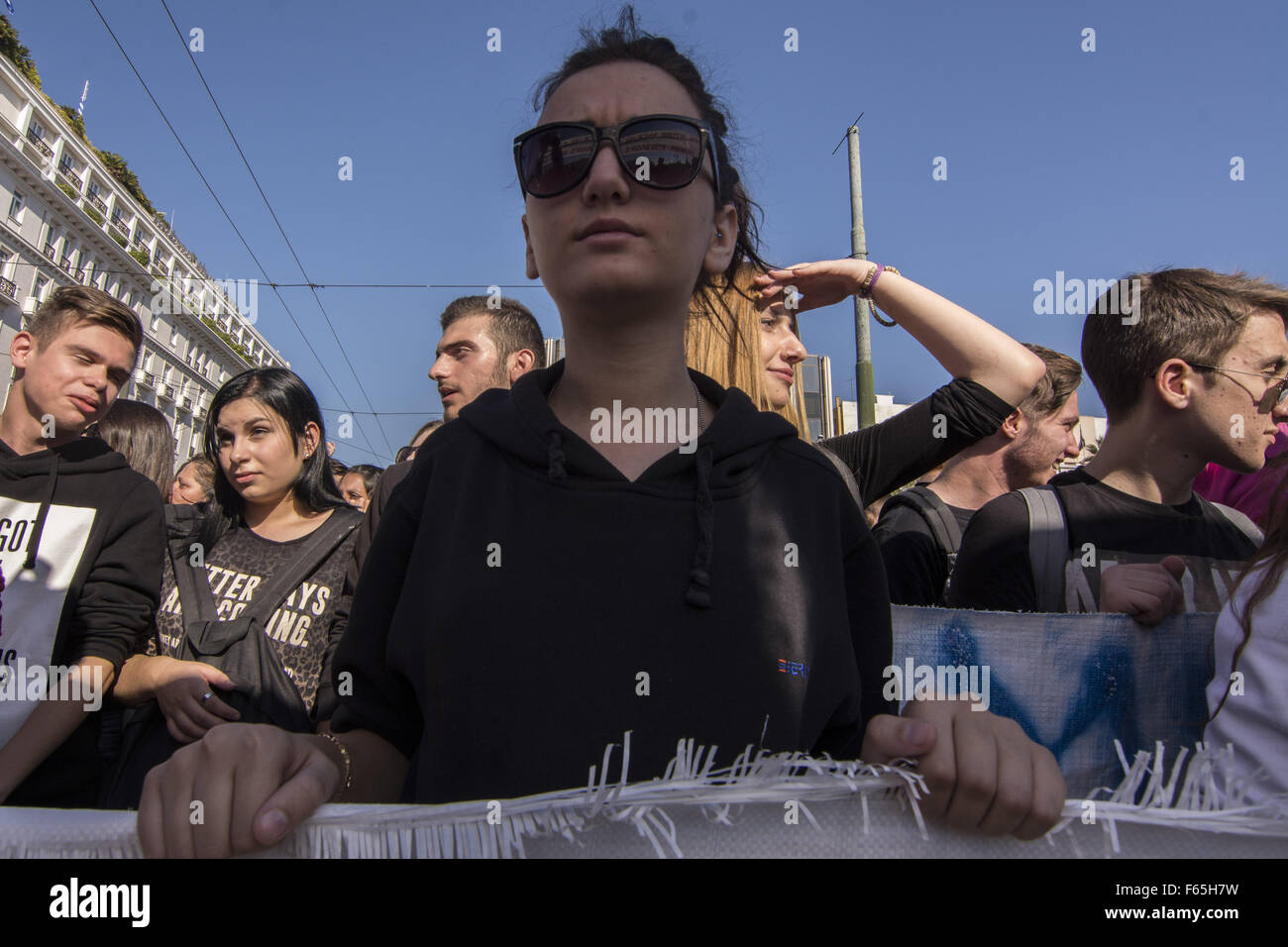 Protesters march towards the Greek Parliament holding banners and ...