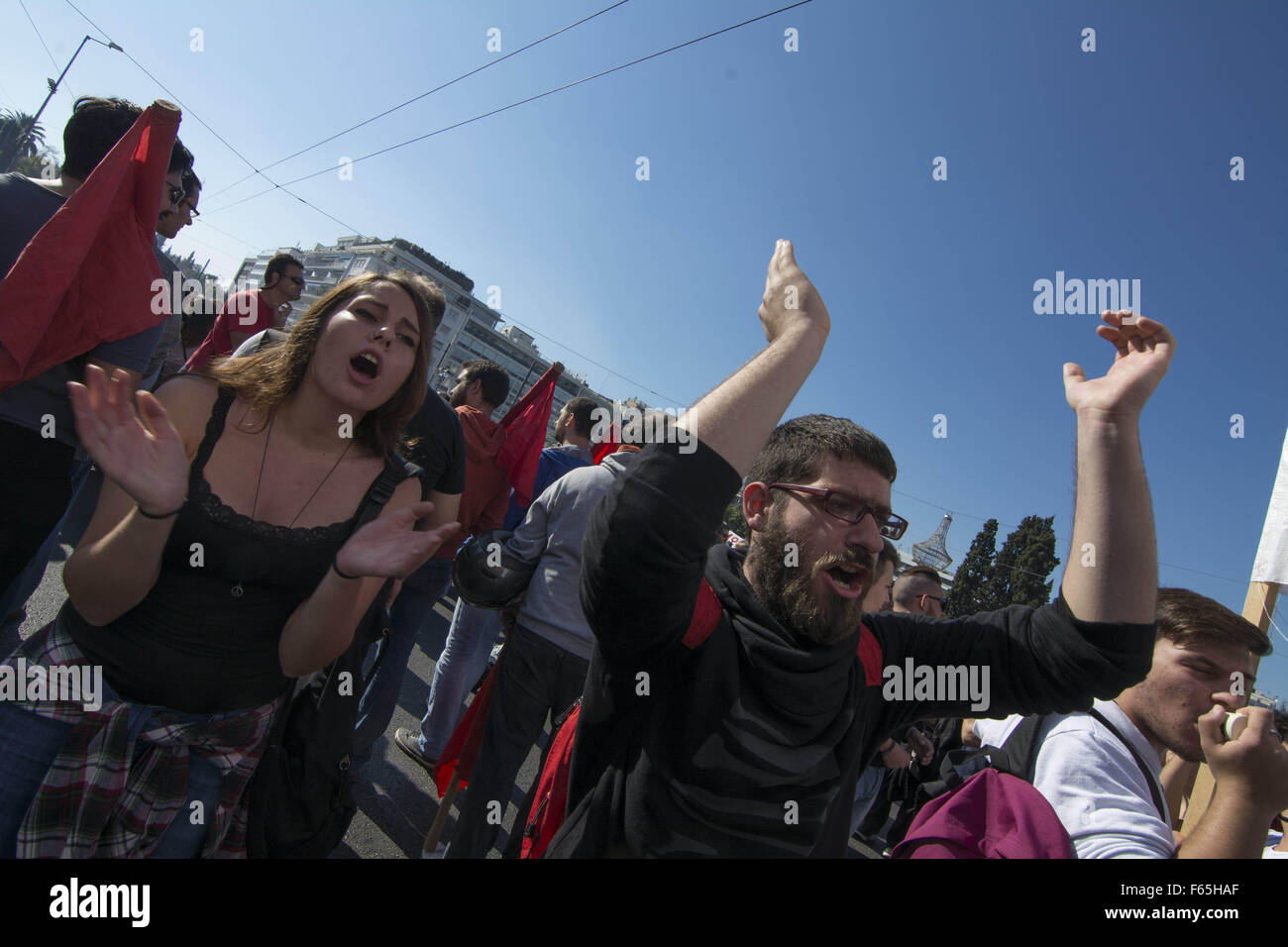 Protesters march towards the Greek Parliament holding banners and ...