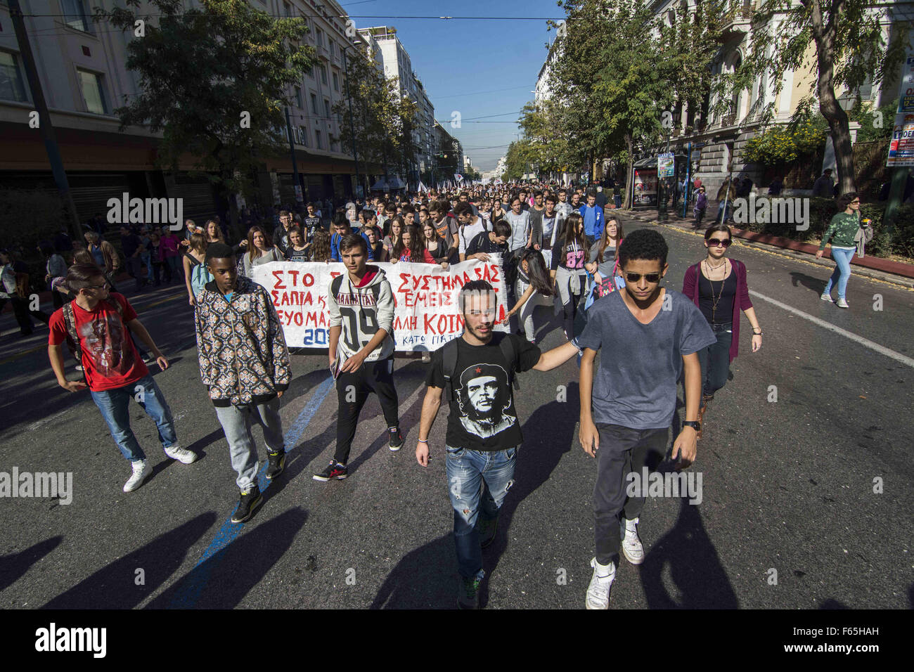 Protesters march towards the Greek Parliament holding banners and ...