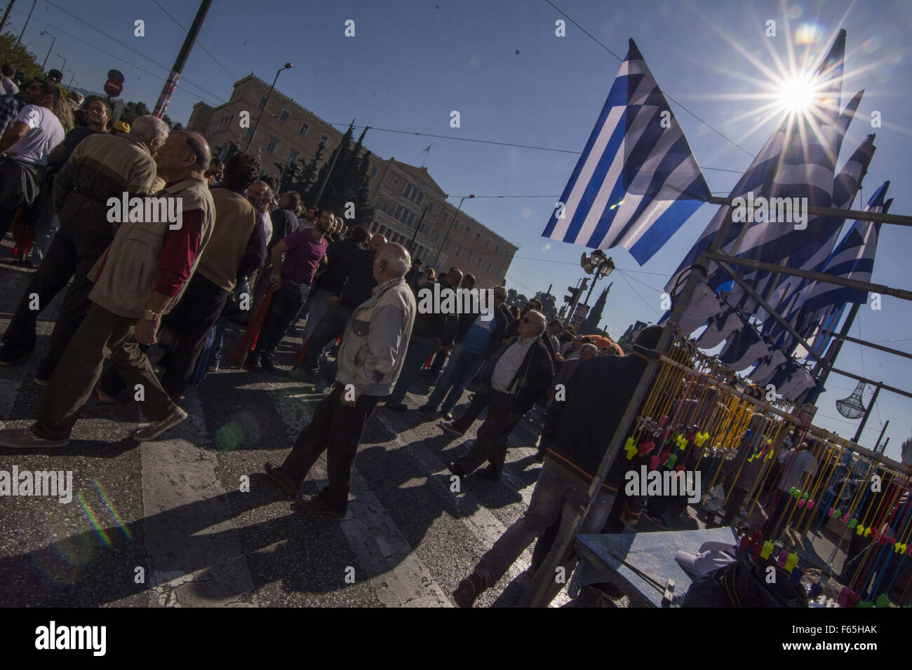 Protesters march towards the Greek Parliament holding banners and ...