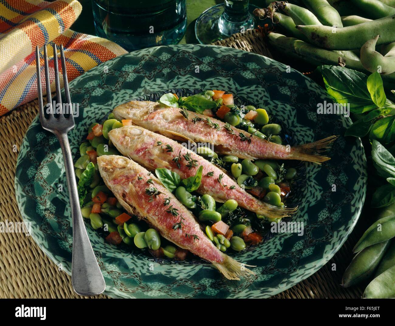Grilled red mullets on a bed of broad bean and basil salad Stock Photo ...