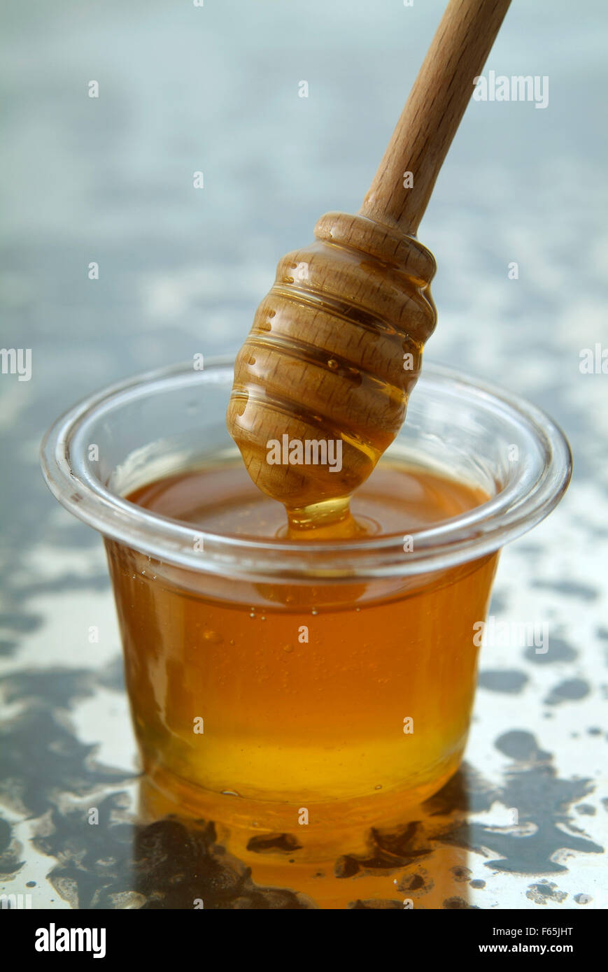 jar of honey with honey stick (topic : honey cooking Stock Photo - Alamy