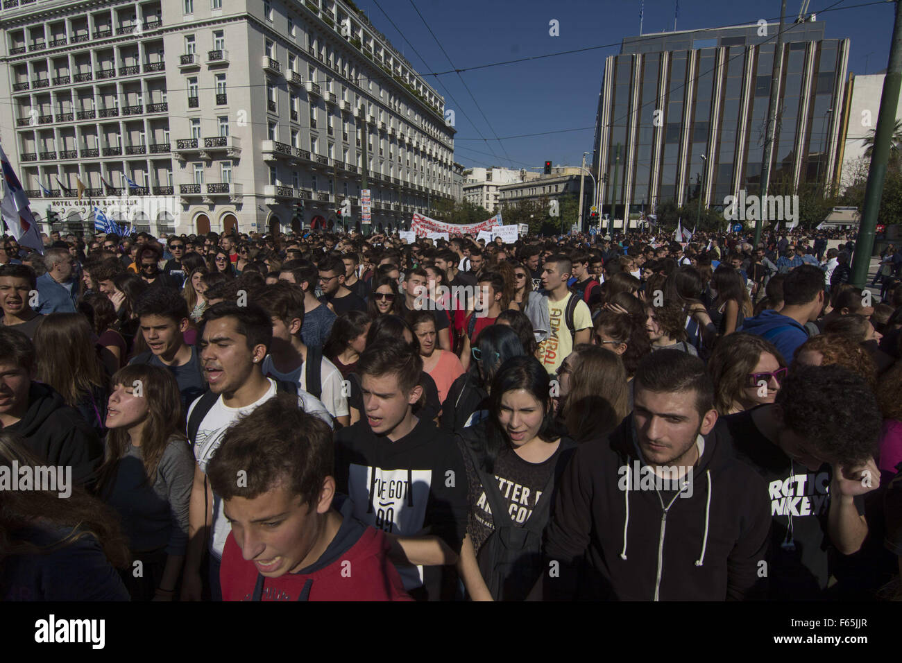 Protesters march towards the Greek Parliament holding banners and ...