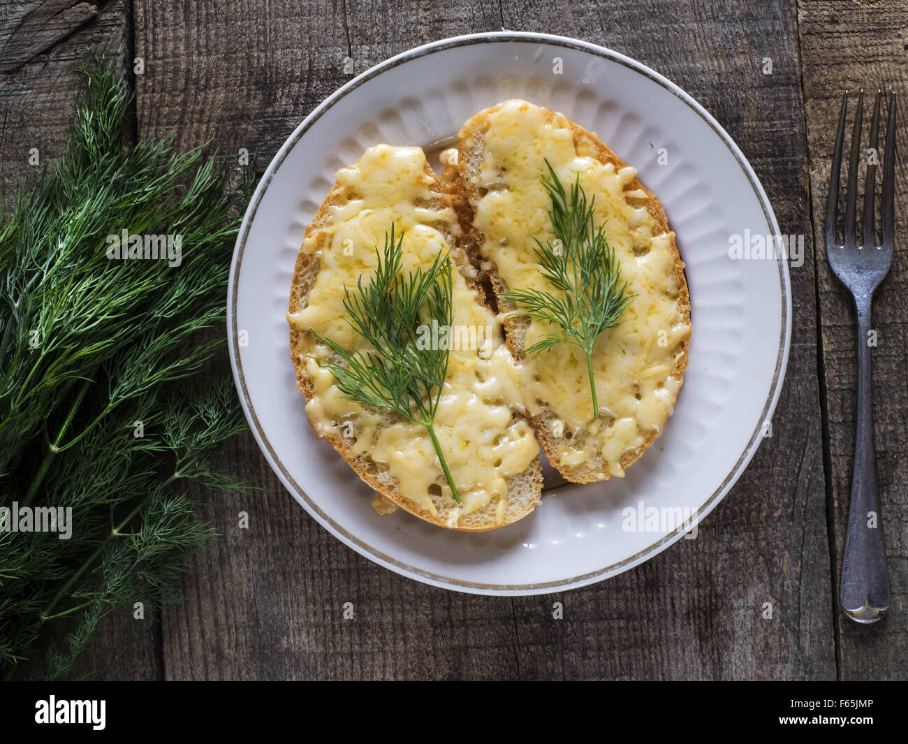 Nov. 7, 2015 - fried toast with grated cheese on old weathering wooden ...