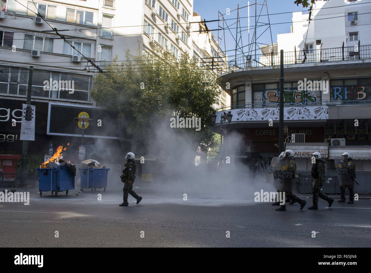 Protesters march towards the Greek Parliament holding banners and ...