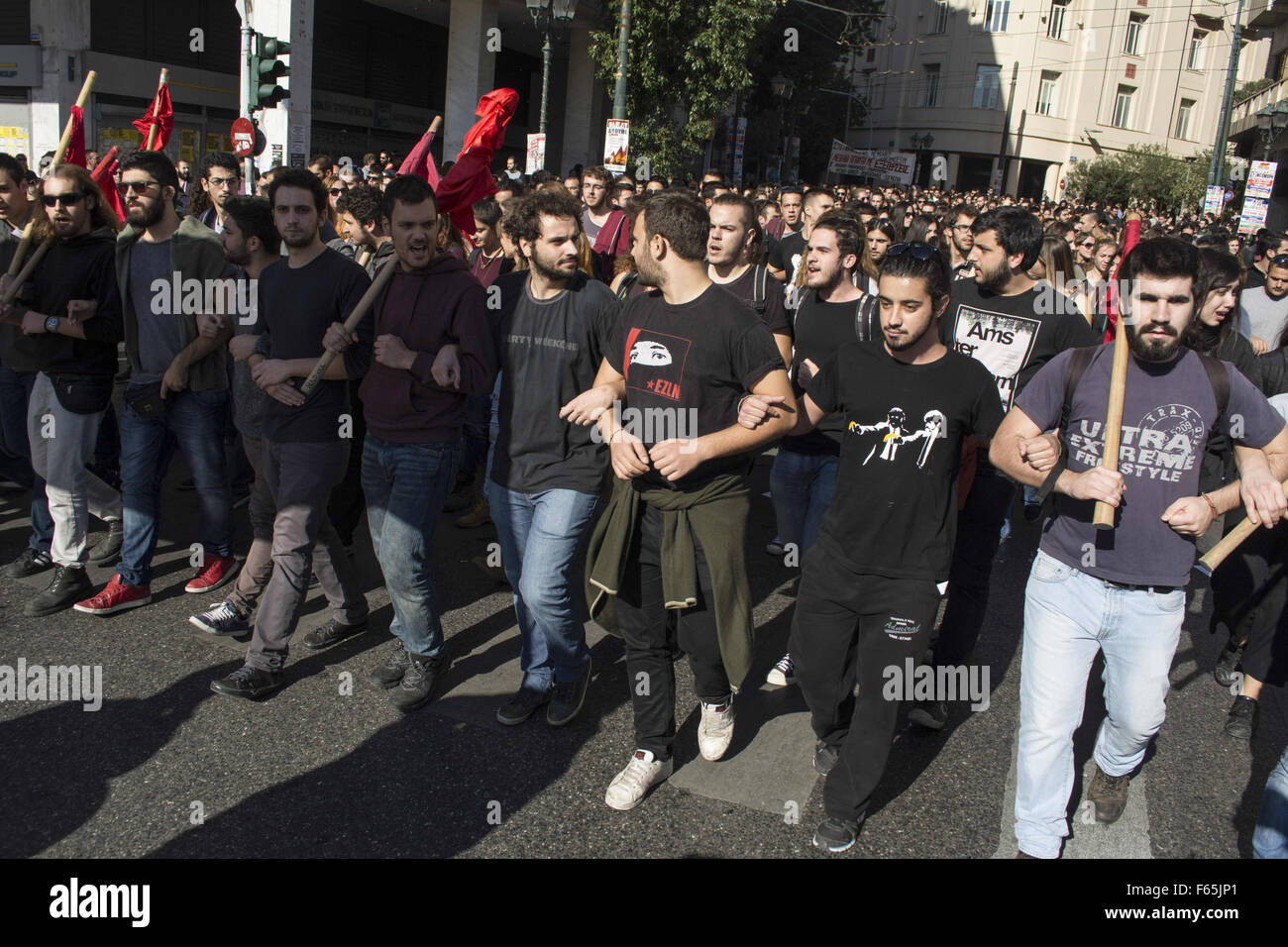 Protesters march towards the Greek Parliament holding banners and ...