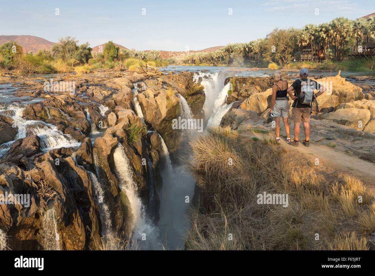 A couple of tourists at the Epupa Falls, Kunene River, Kunene Province ...