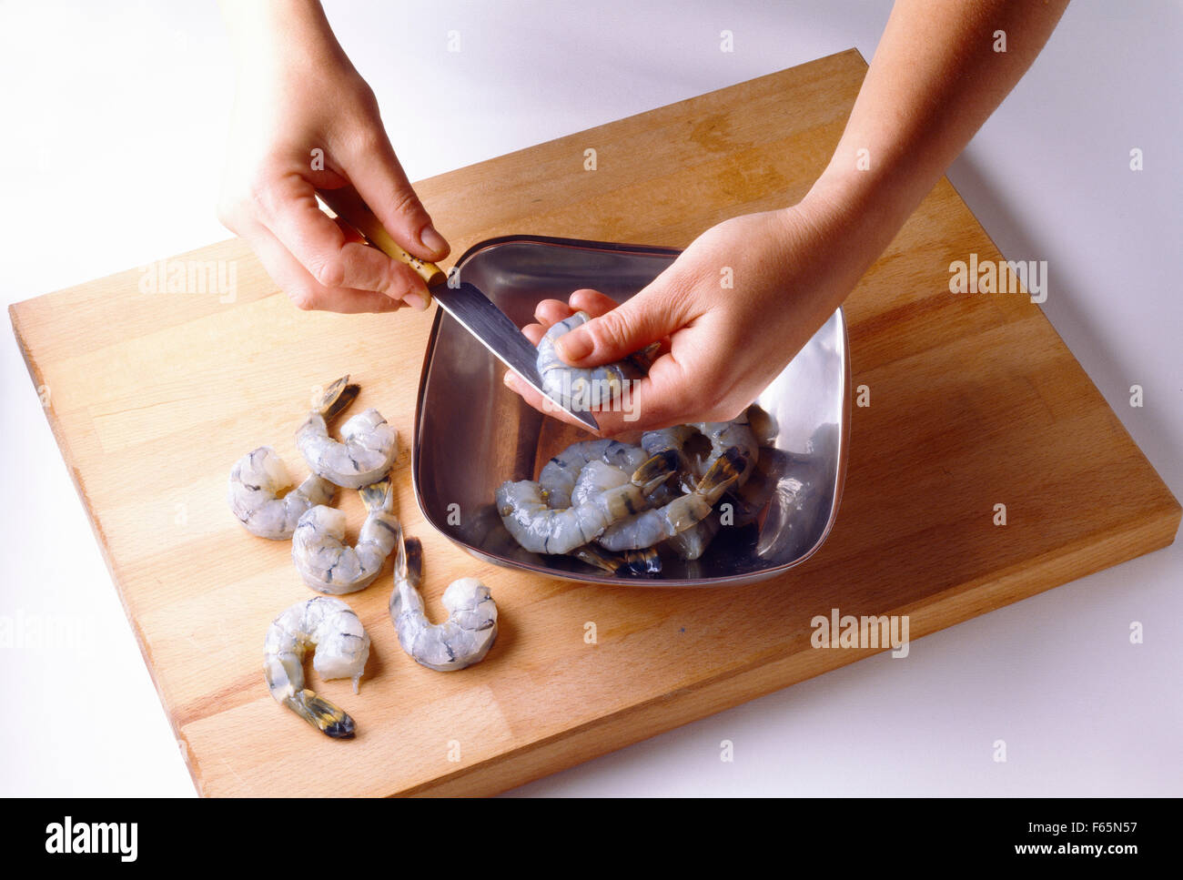 Slicing the raw shrimp in half Stock Photo - Alamy