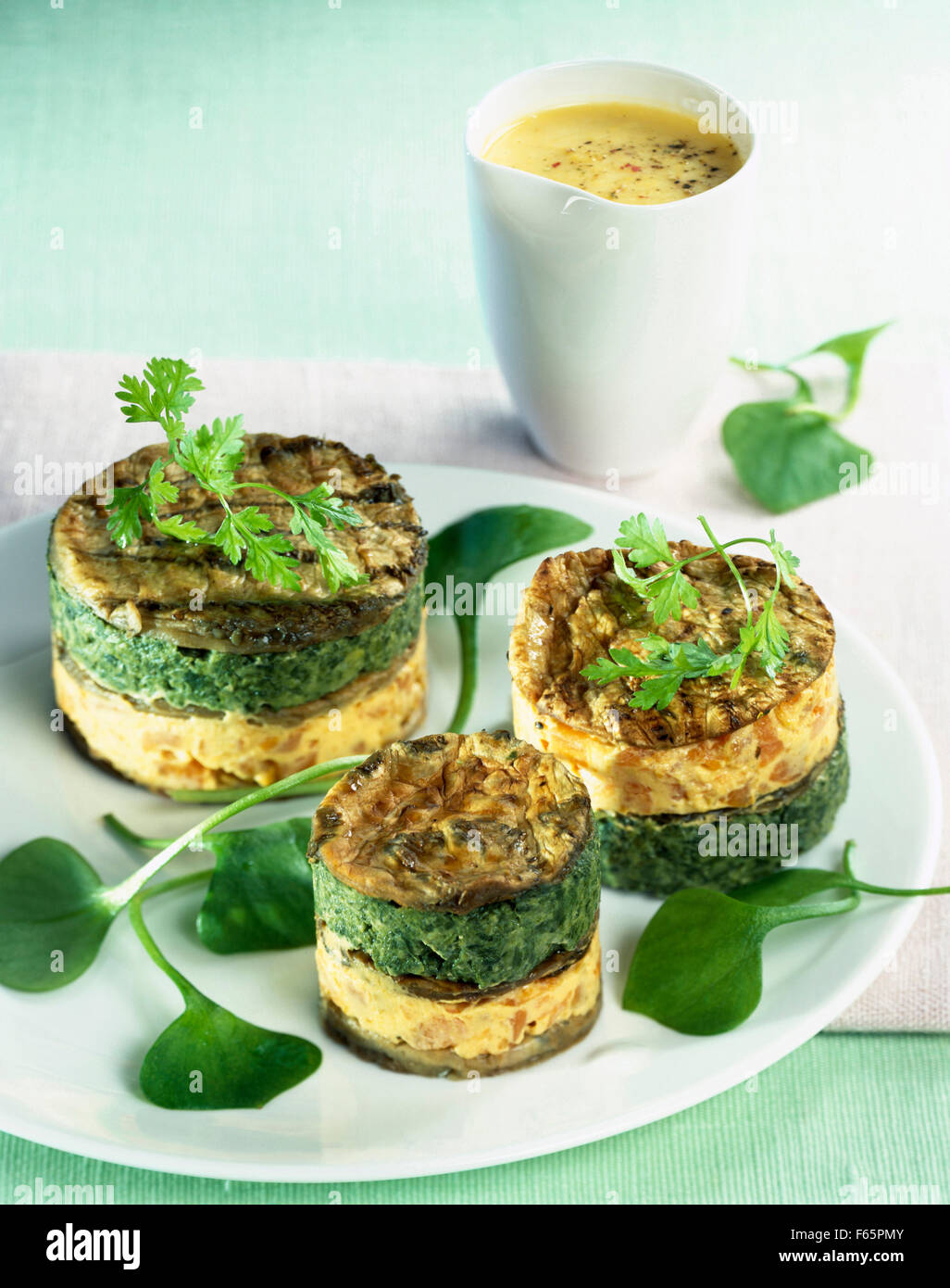 Vegetable charlotte with yellow pepper coulis Stock Photo - Alamy