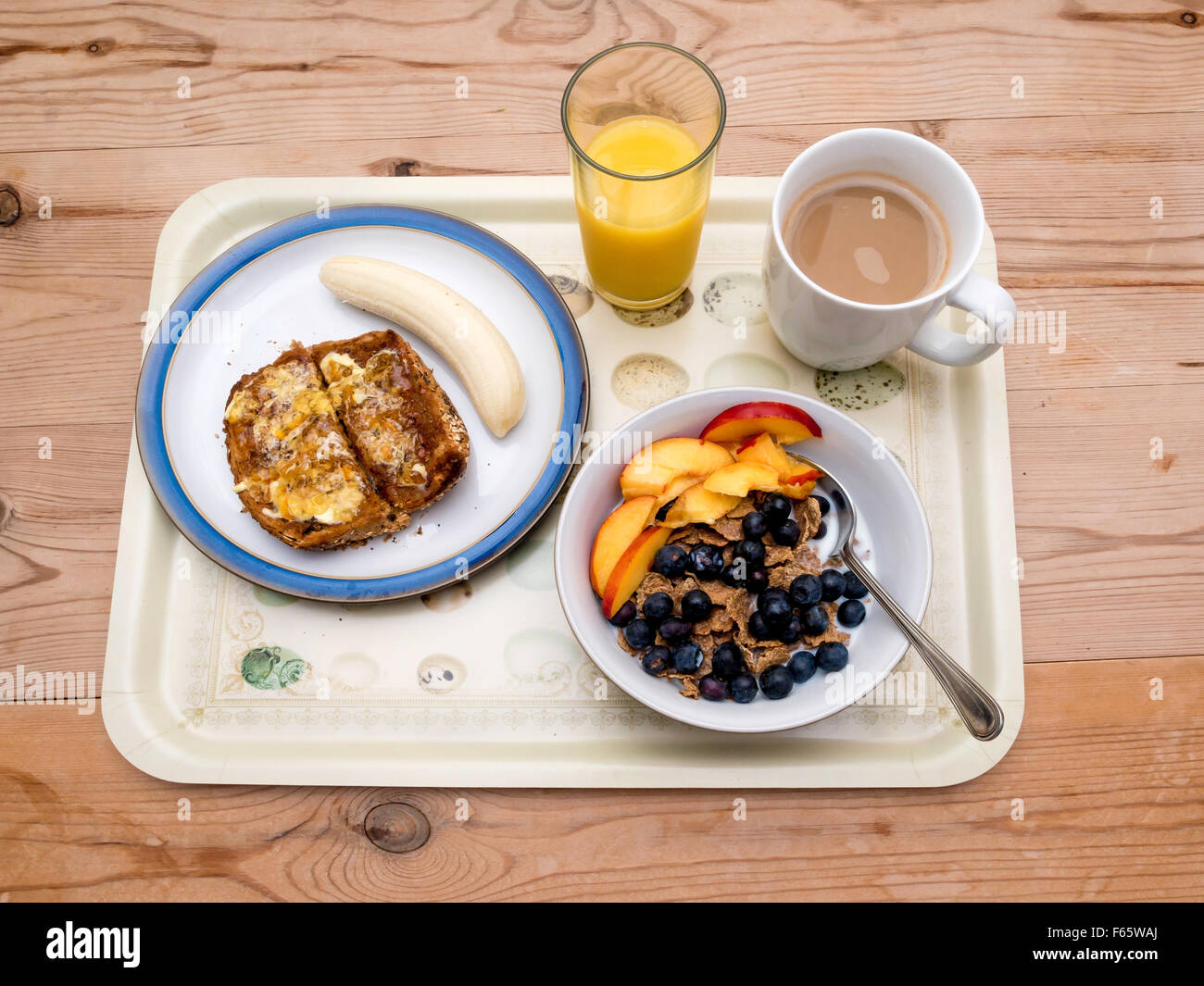 A breakfast tray cereal bran flakes with blueberries and nectarine ...