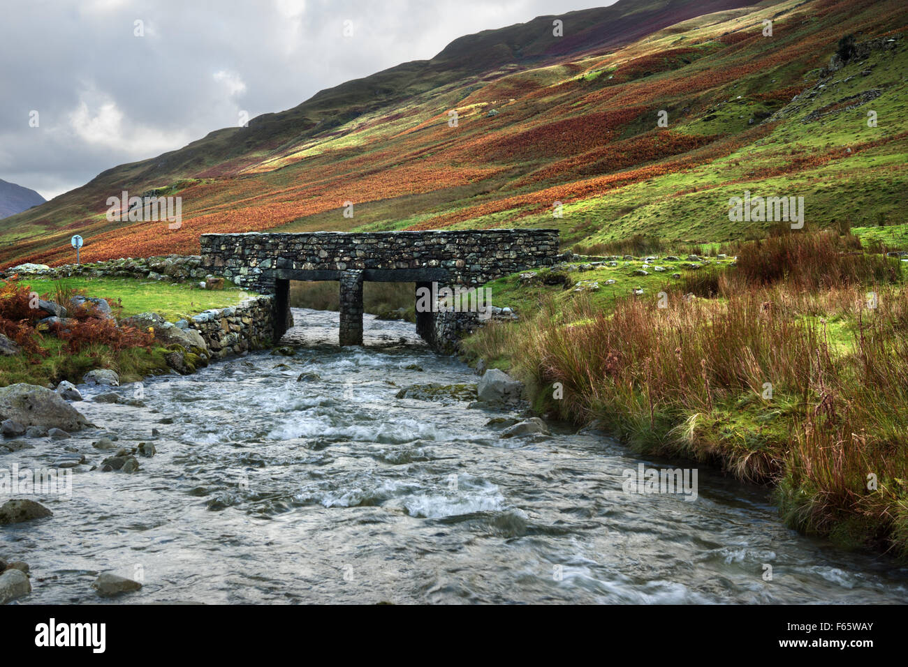 Stone built bridge across a lively stream in Honister Pass, Lake ...