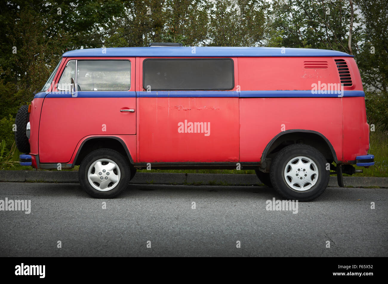 Old retro van on a campsite red color copy space Stock Photo - Alamy