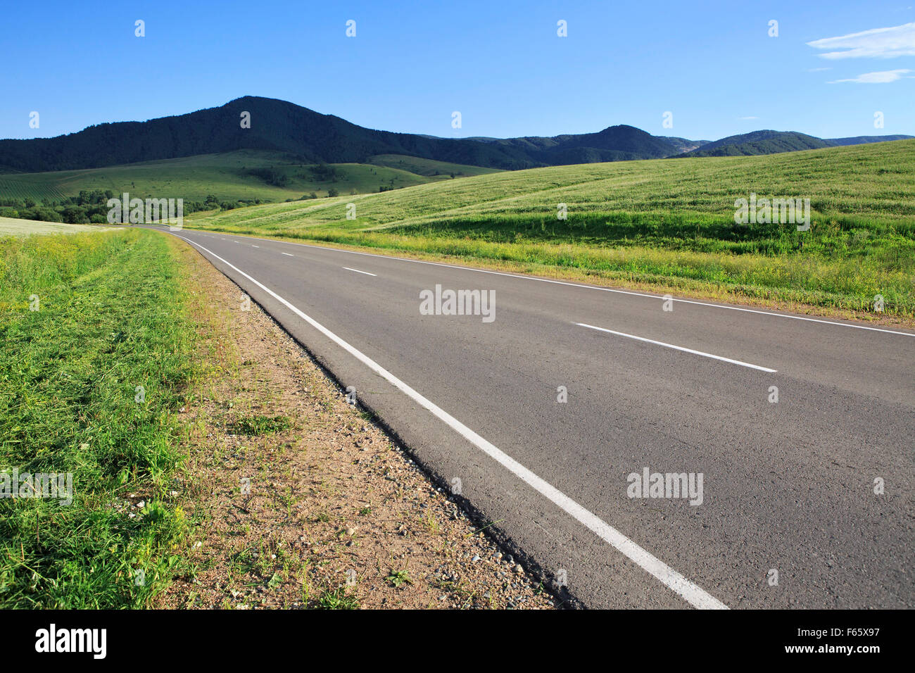 Road among farm fields Stock Photo - Alamy