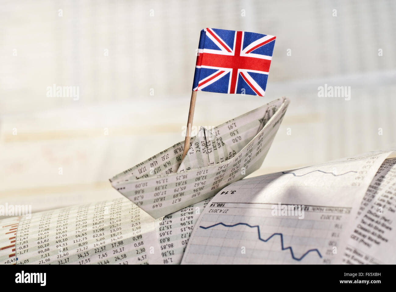 Paper ship with British flag on newspaper pages with rate tables Stock ...
