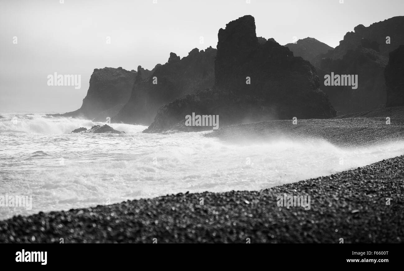 Sea coast volcanic rocks and black beach sand at Snaefellnes Peninsula ...