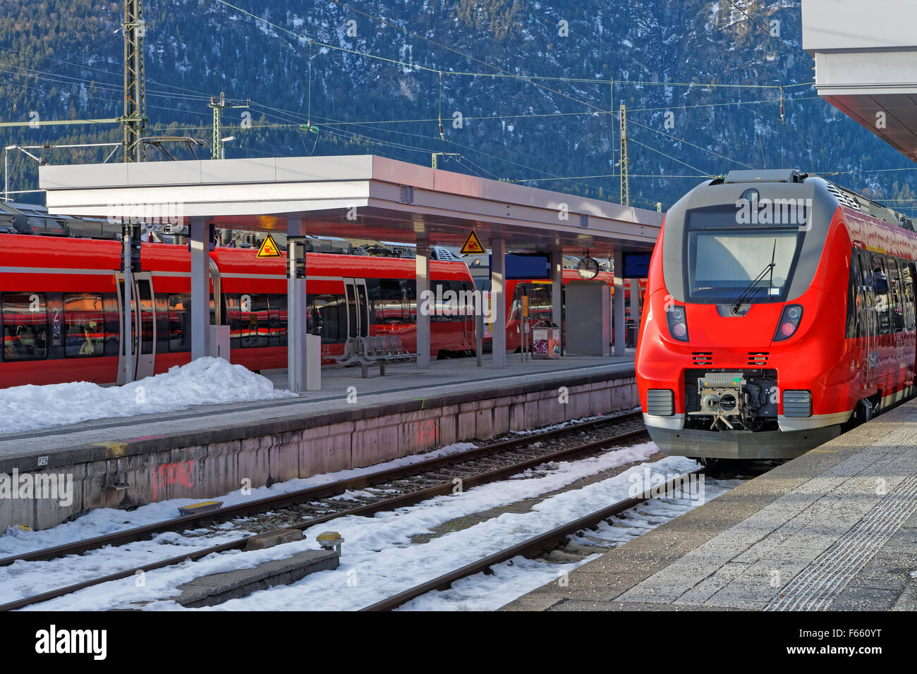 Shiny red high-speed train is waiting for passengers at Garmisch ...