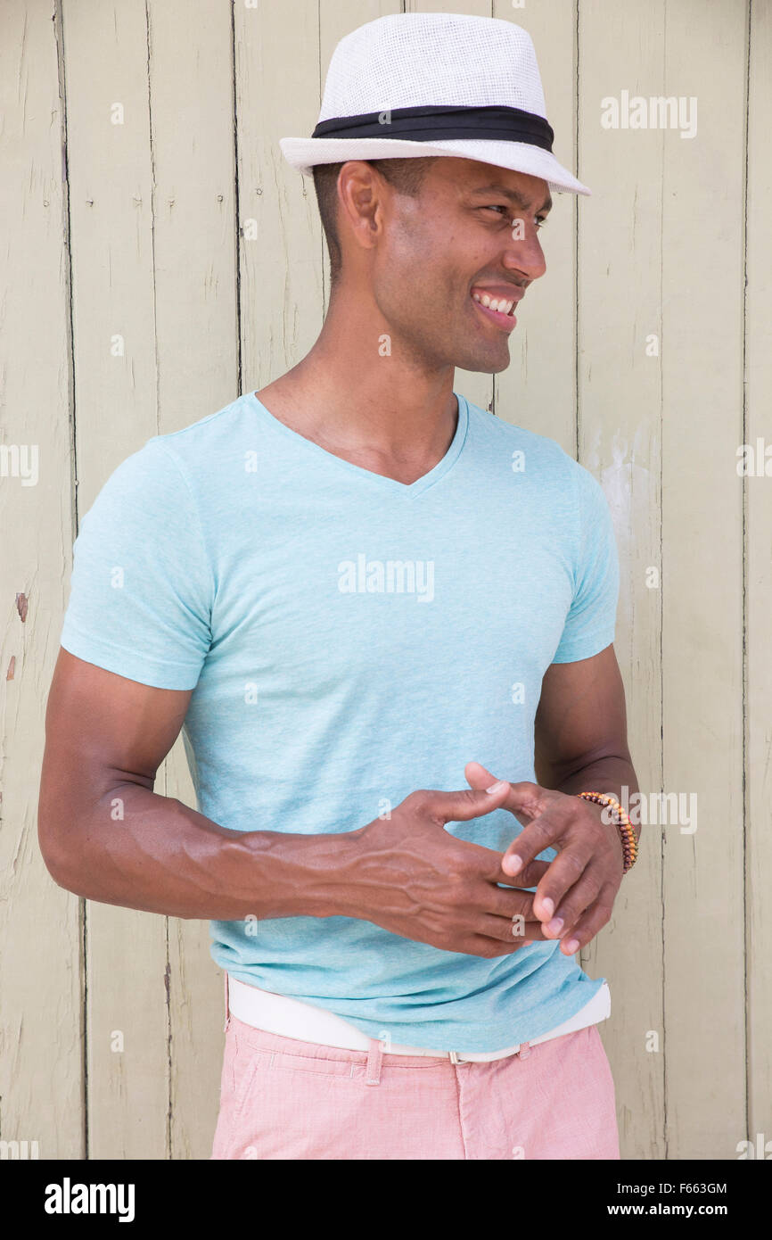 Portrait of an ethnically ambiguous man wearing a fedora and light ...