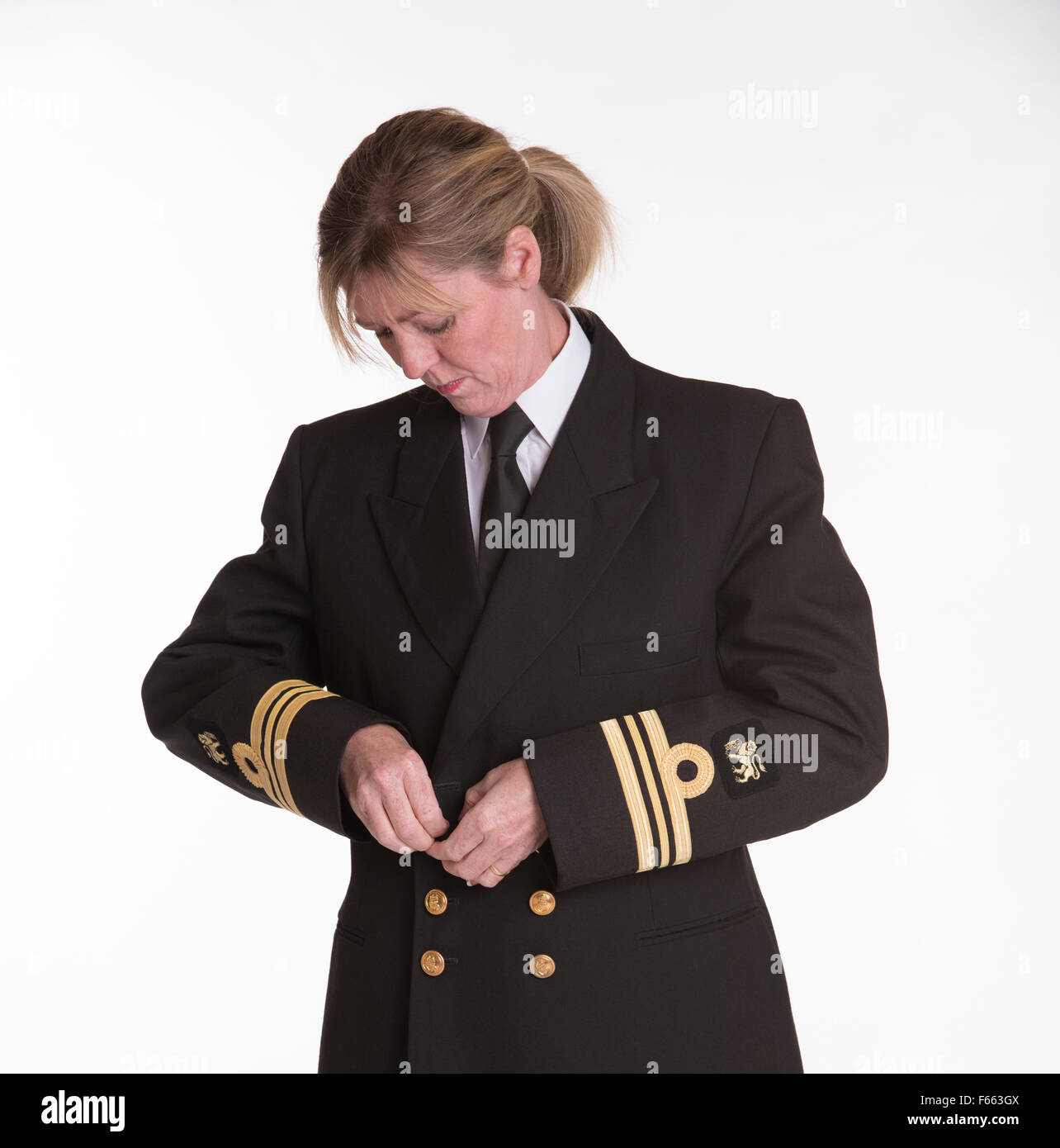Lt Commander female South African naval officer getting dressed into ...