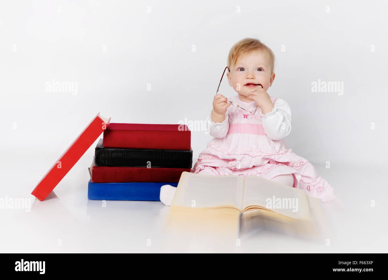 Baby reading book Stock Photo - Alamy