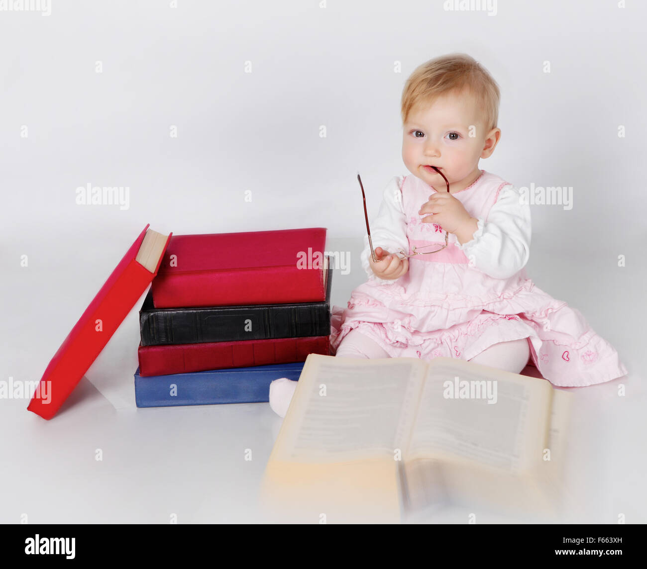 Baby reading book Stock Photo - Alamy