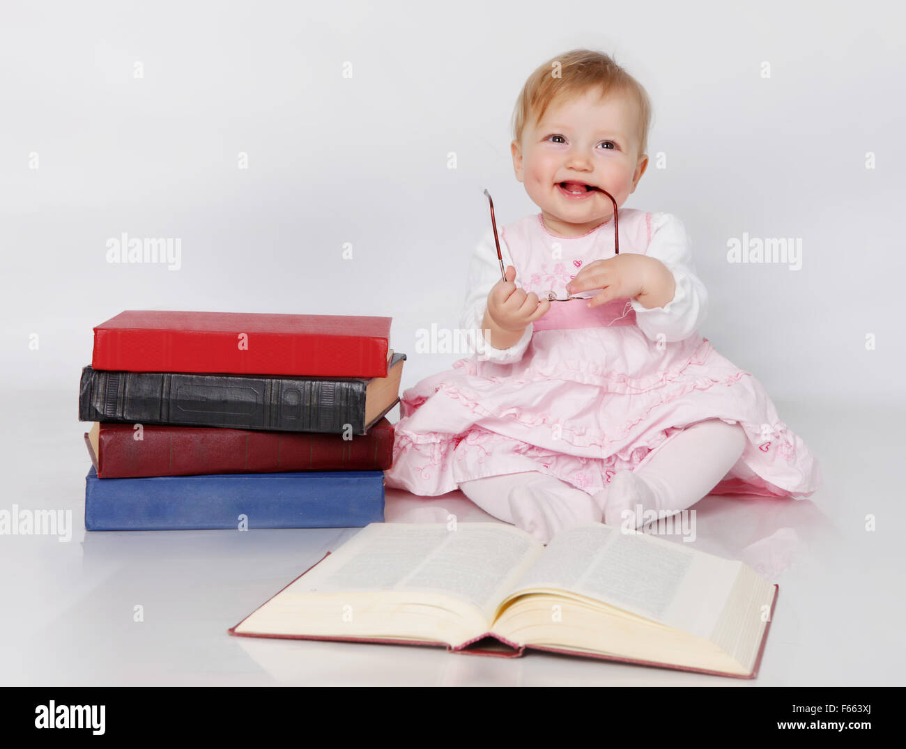 Baby reading book Stock Photo - Alamy