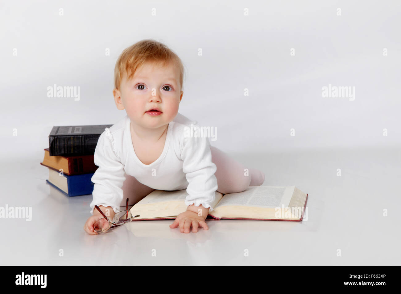 Baby reading book Stock Photo - Alamy